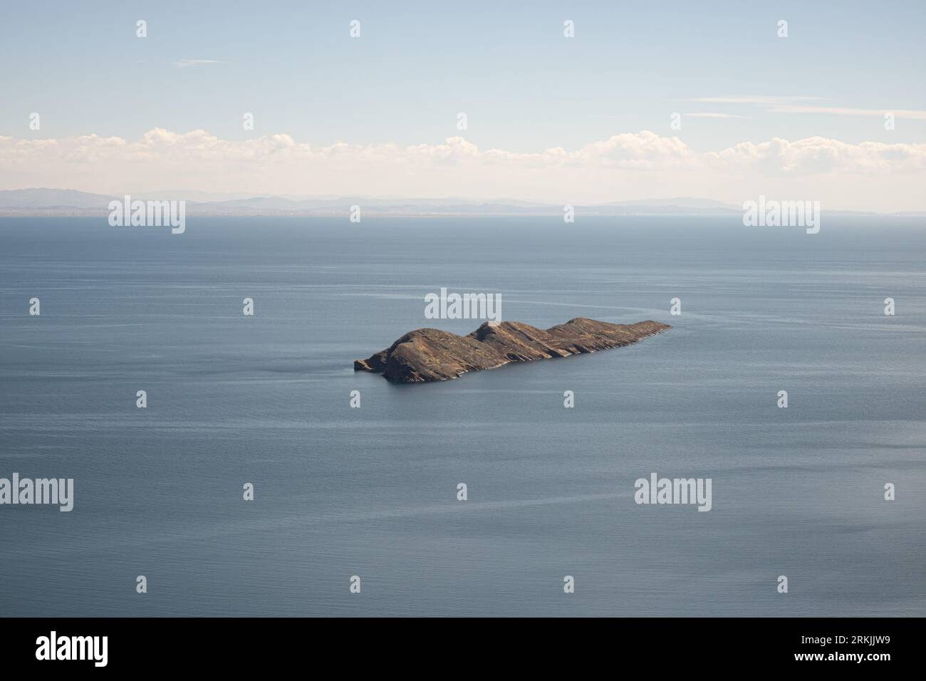 An aerial view of a small island surrounded by crystal blue ocean ...