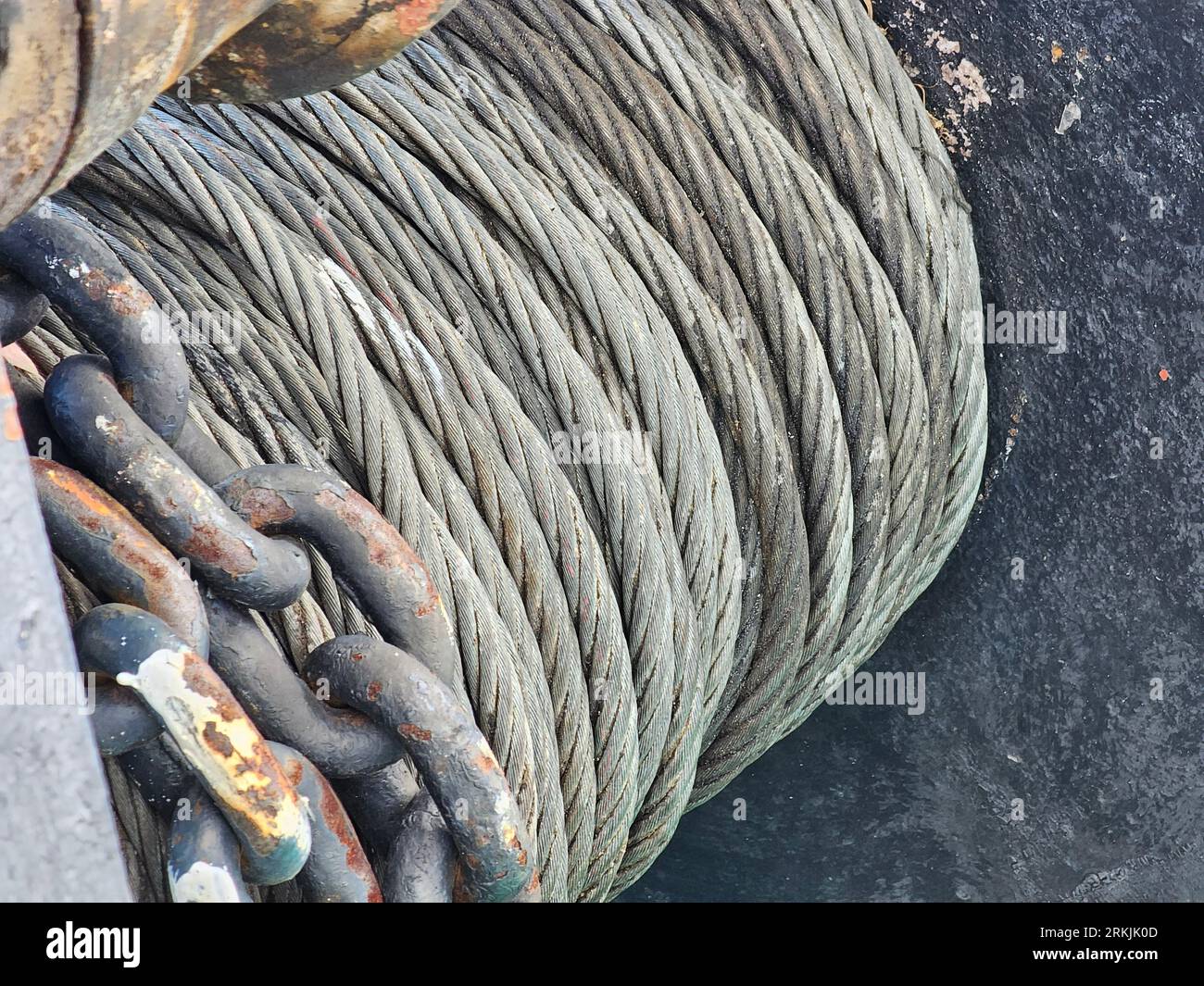 A weathered rope securely fastened to a wooden pole in a waterfront ...