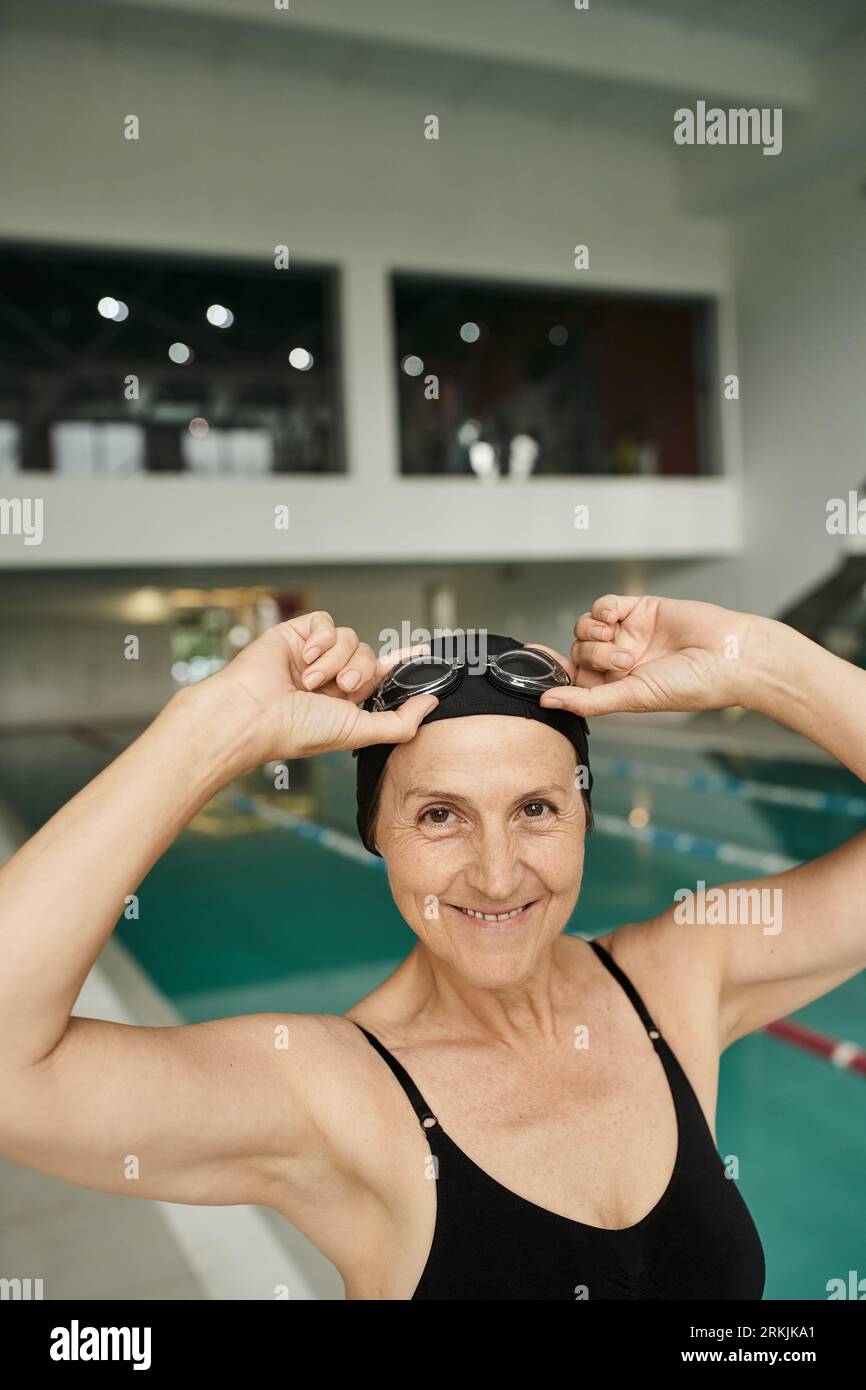 Joyful Middle Aged Woman In Goggles And Swim Cap Swimmer In Wellness