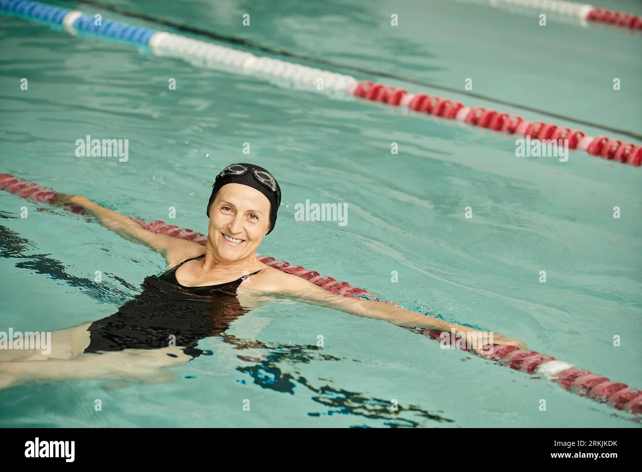 Cheerful Middle Aged Woman Swimming In Pool Smile Swim Cap And