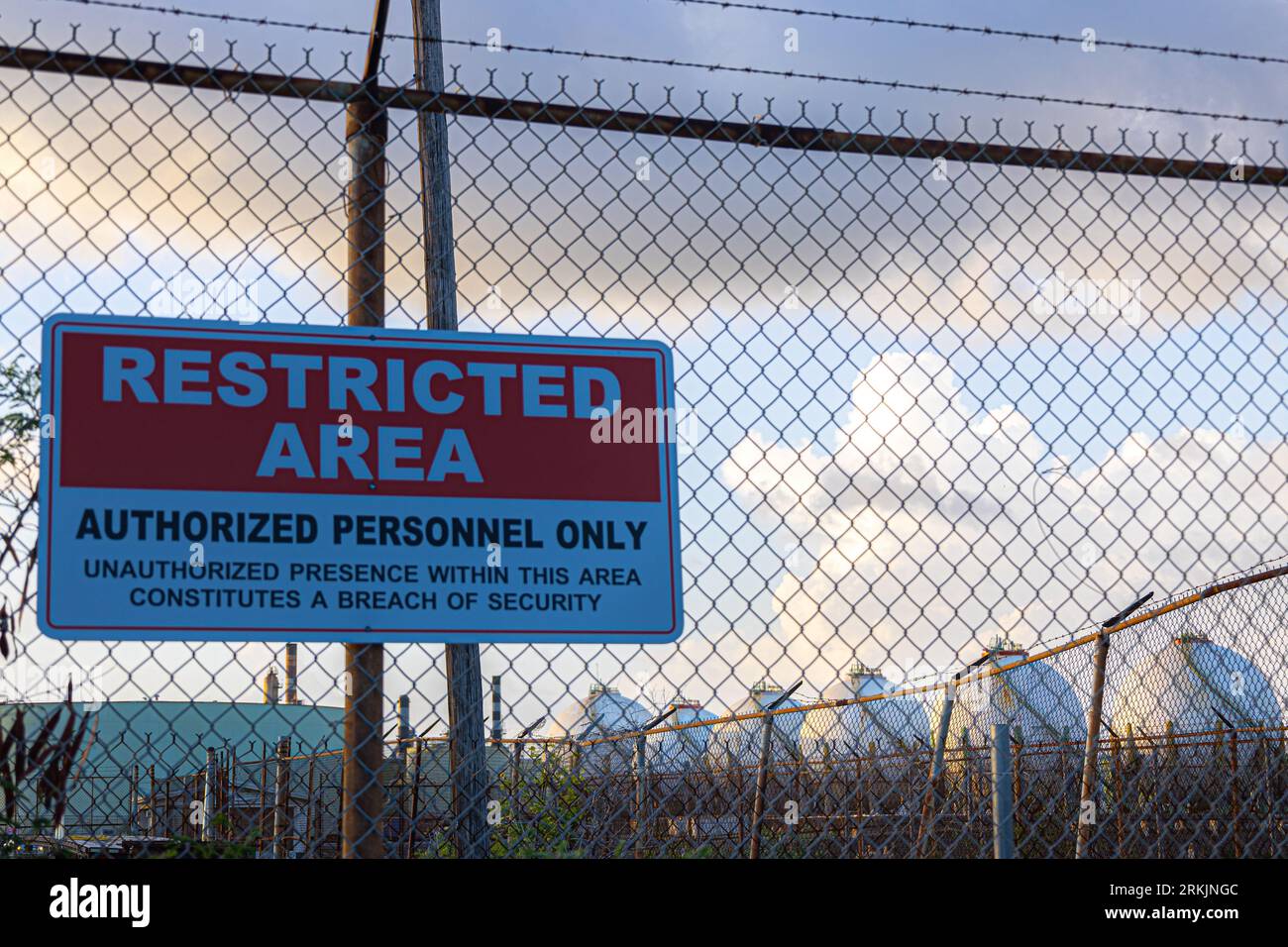 A vibrant red and white sign with bold lettering, reading 'restricted ...