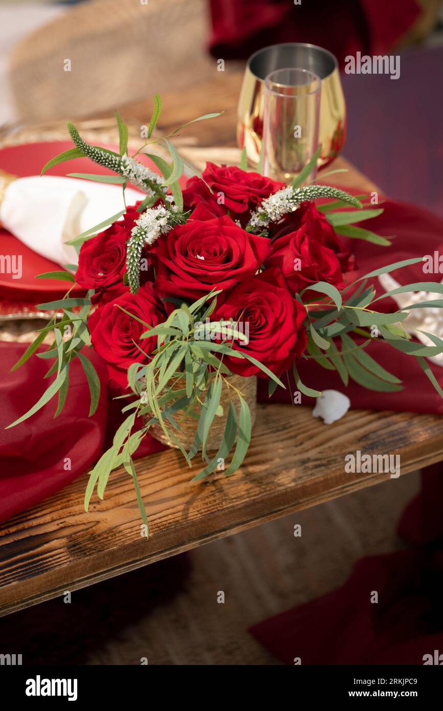 A romantic beach proposal with red highlights and decor featuring red ...