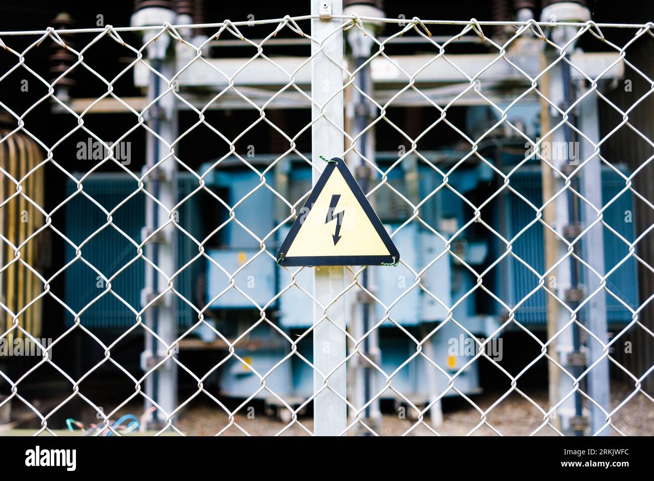 Danger sign, high voltage, on the fence of an electrical transformer ...