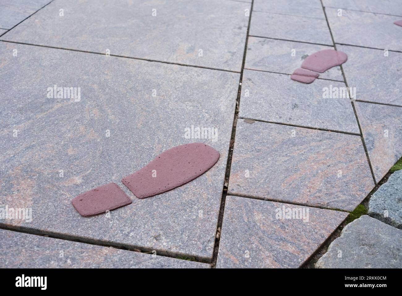 Footprint marks on the ground, painted to mark a tourist route in a ...