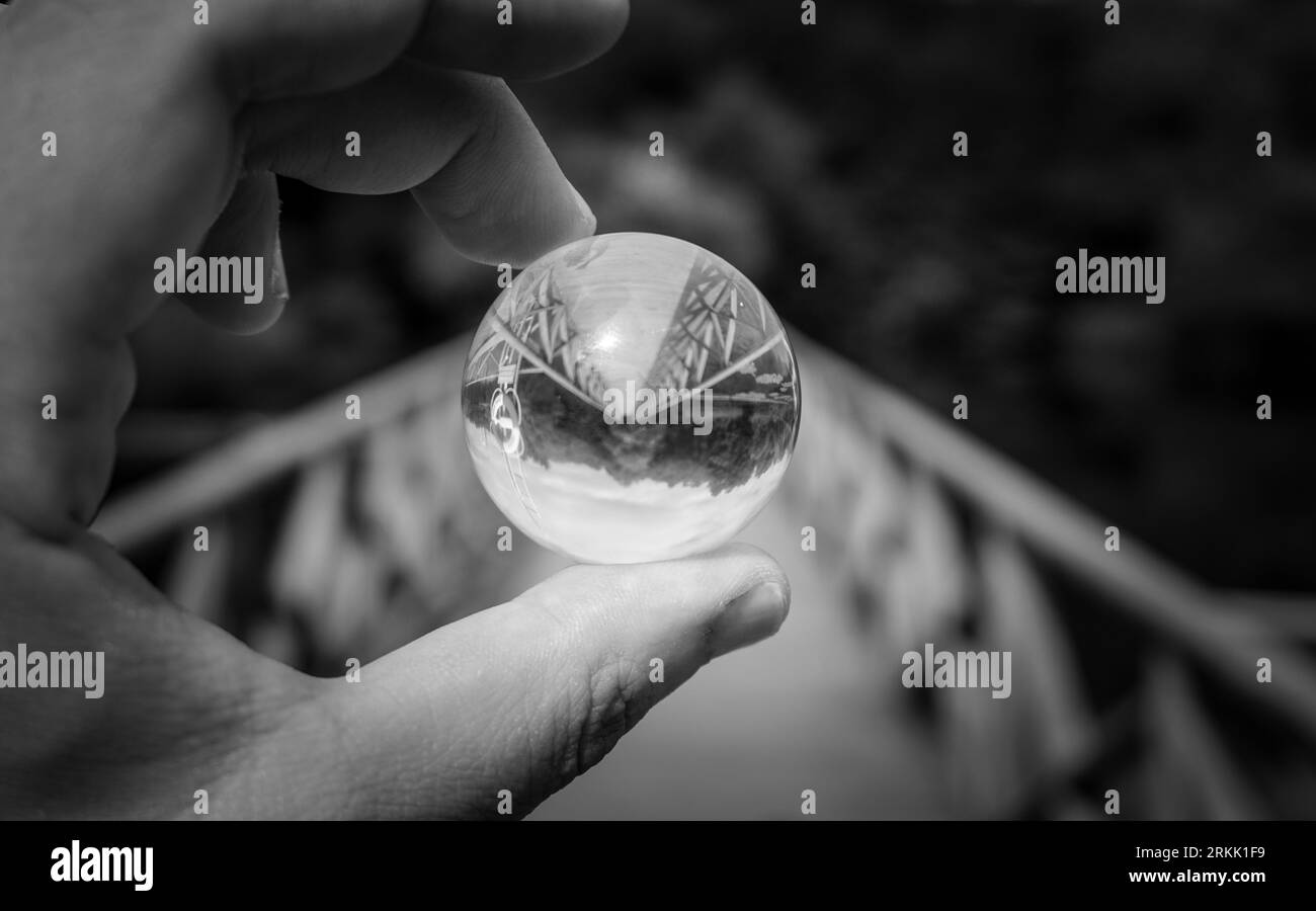 Cropped hand holding a crystal ball Stock Photo - Alamy