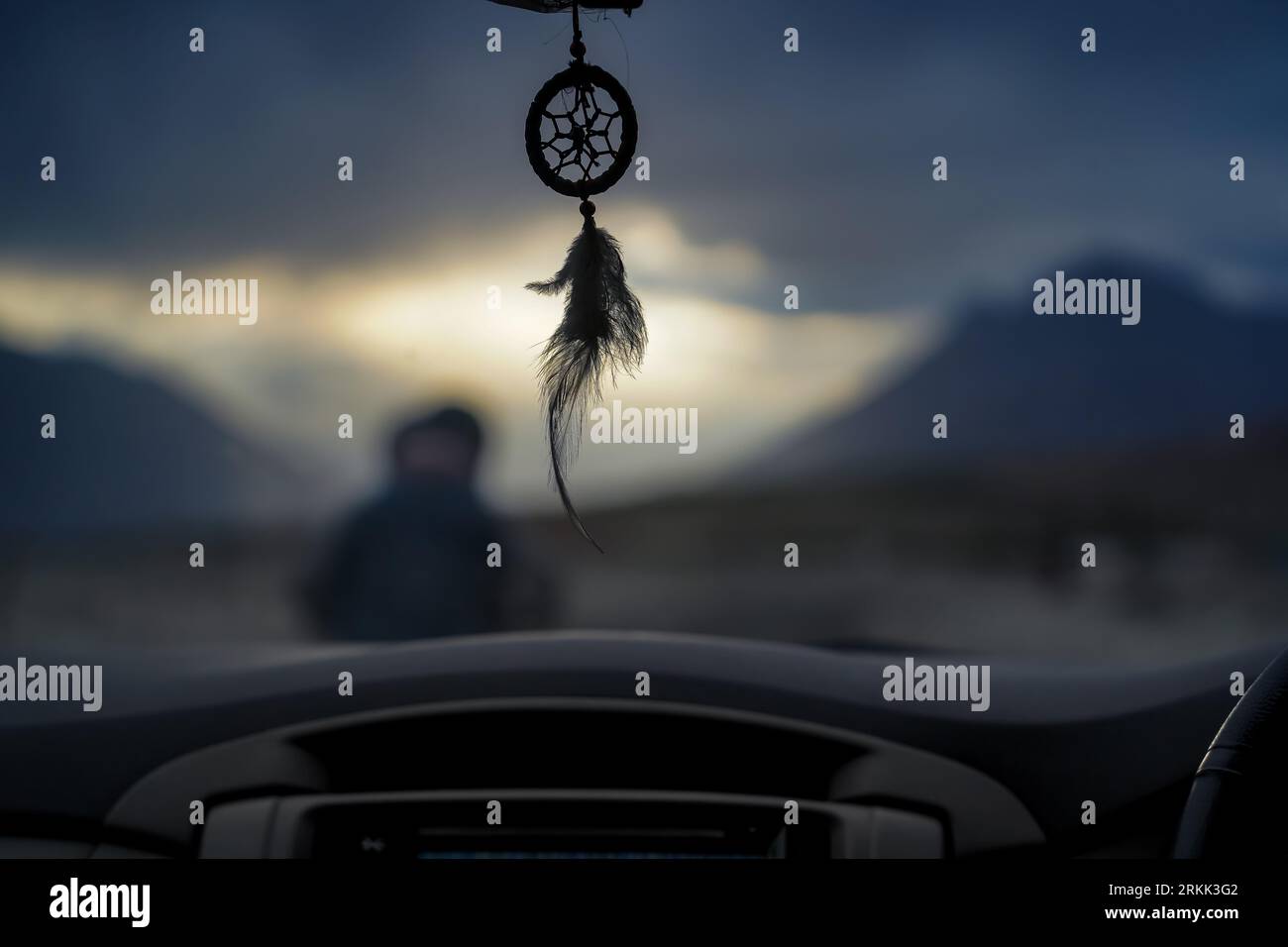 The interior of a car featuring a dream catcher draping from the ...