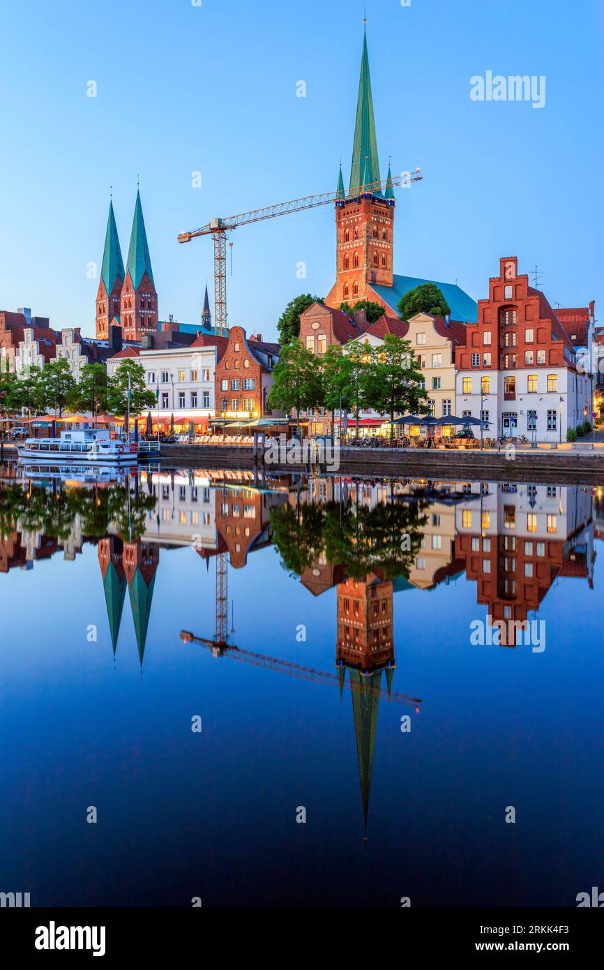 Lubeck pier architecture reflected in the water of Trave River at the ...
