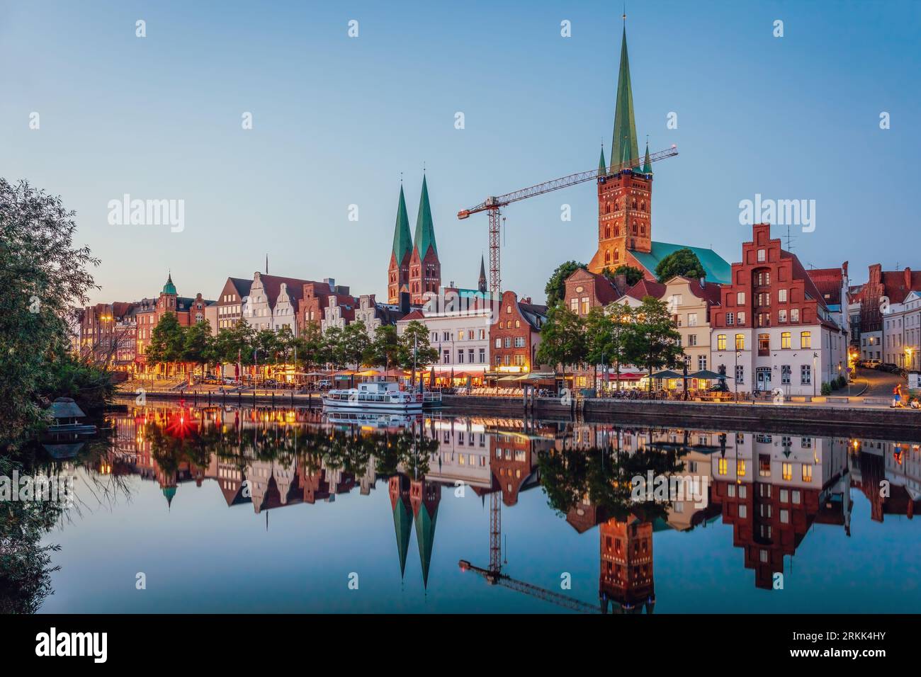 Lubeck pier architecture reflected in the water of Trave River at the ...