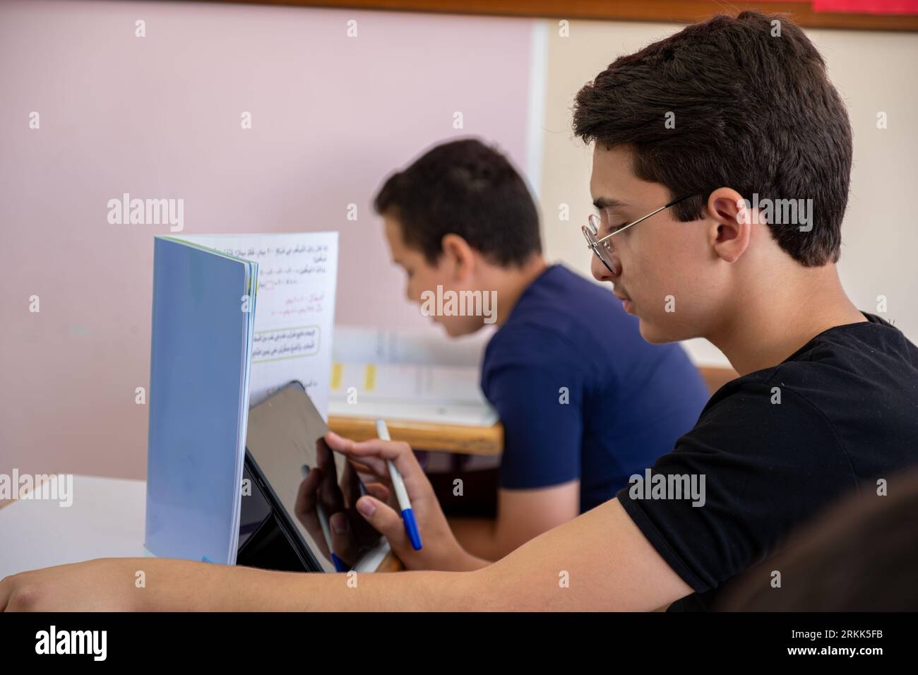 Student using tablet in studying in class room Stock Photo - Alamy