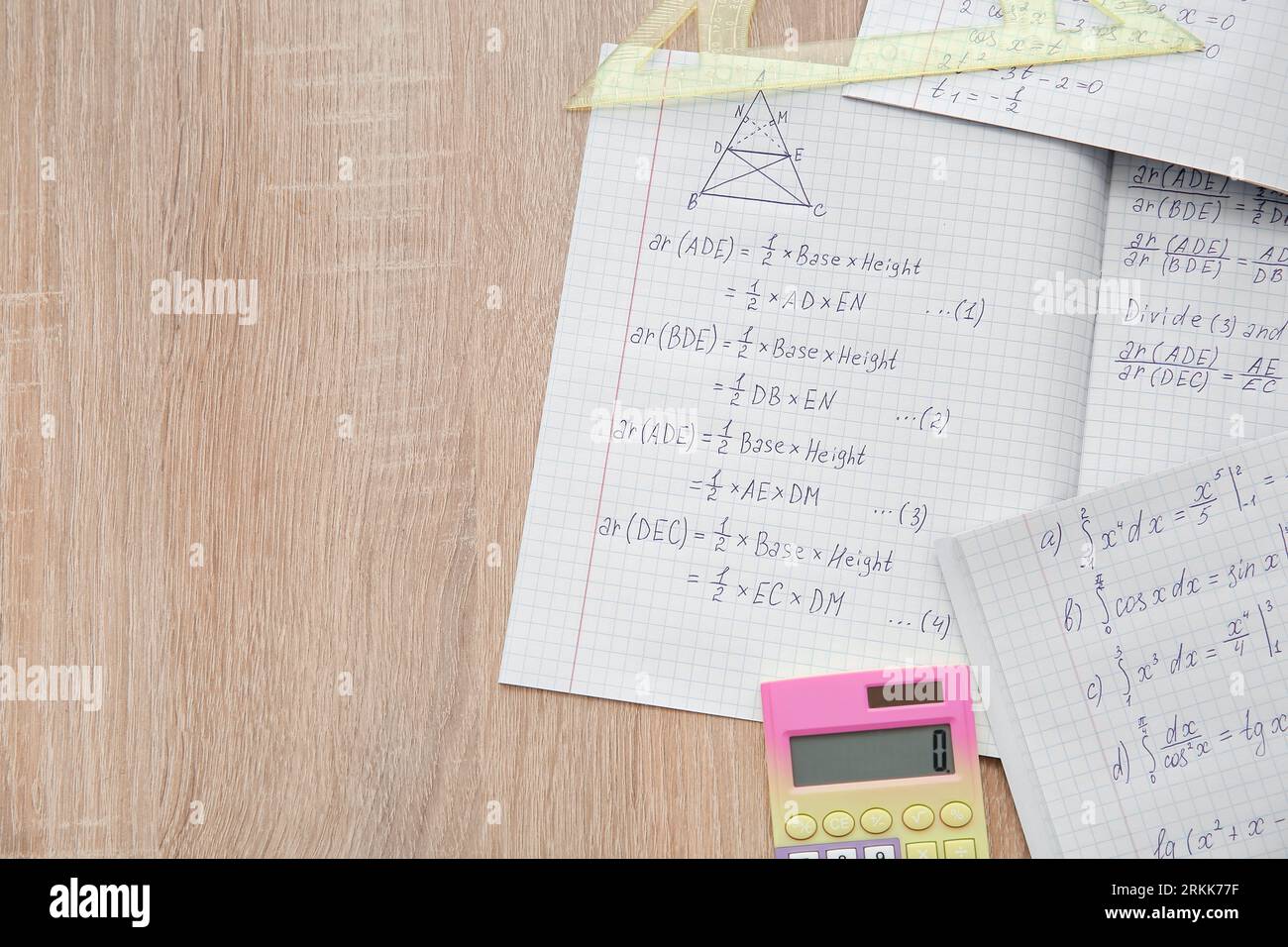 Open copybooks with math formulas and stationery on wooden table Stock ...