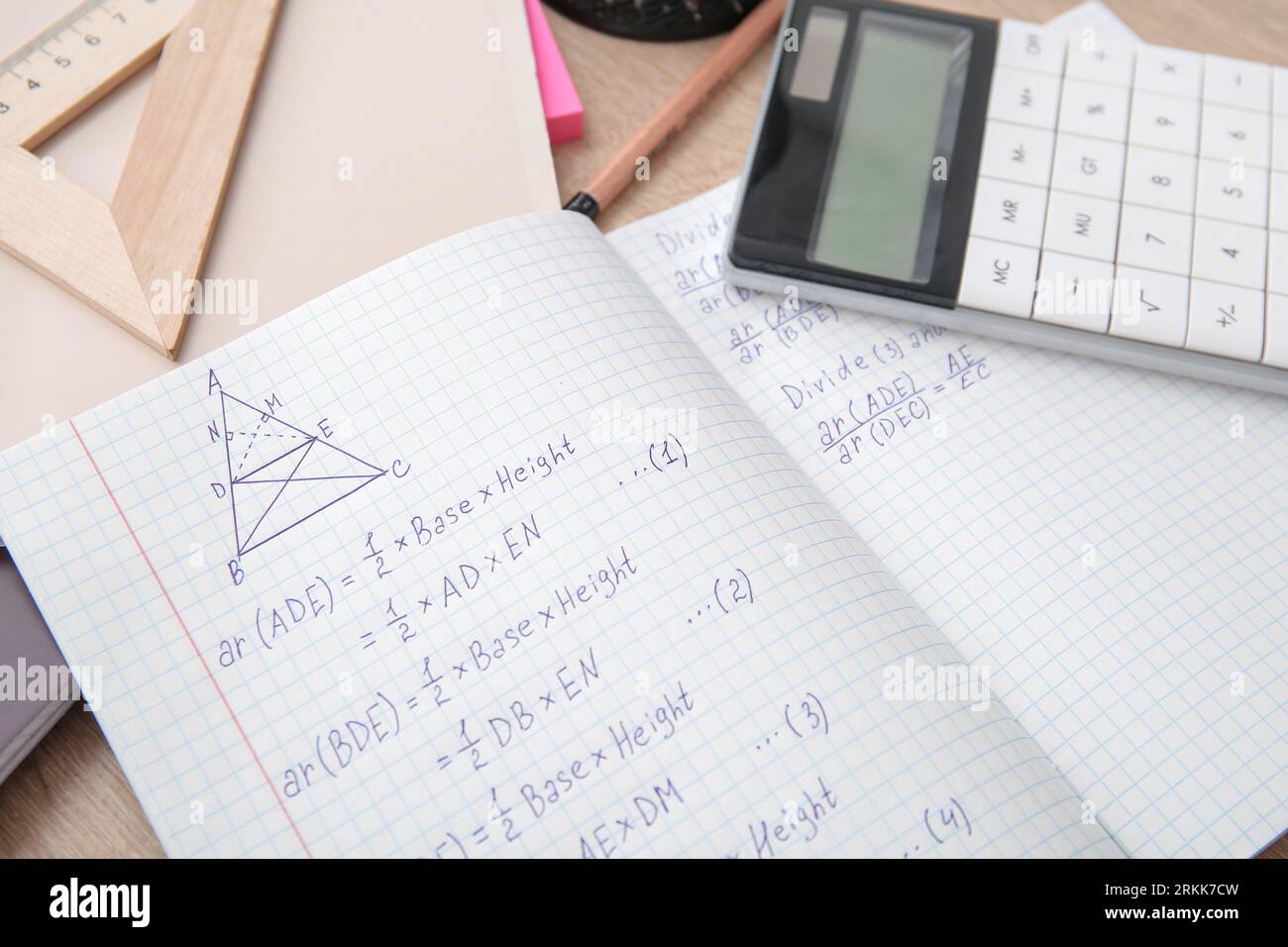 Open copybook with math formulas and calculator, closeup Stock Photo ...