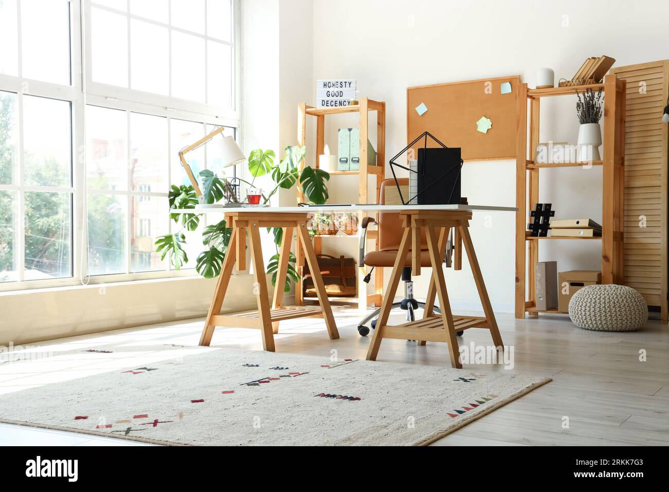 Interior of light office with workplace and shelving units Stock Photo ...