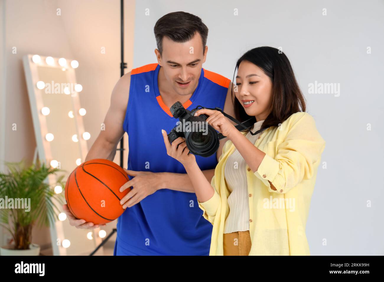Female photographer working with basketball player in studio Stock ...