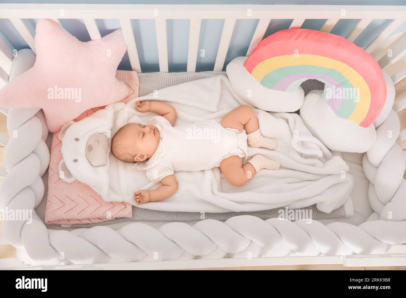 Cute baby lying in crib, top view Stock Photo - Alamy