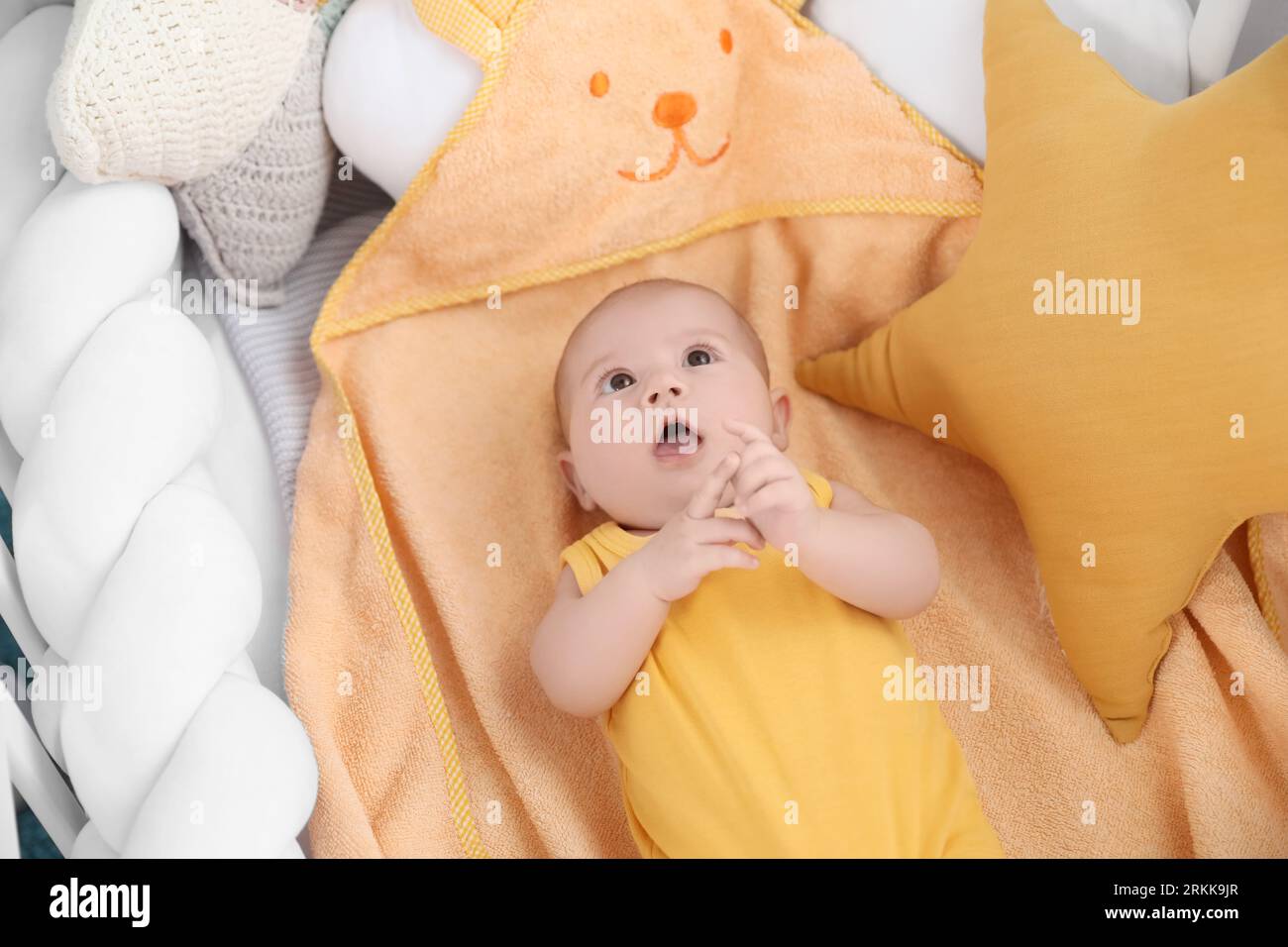 Cute baby lying in crib, top view Stock Photo - Alamy