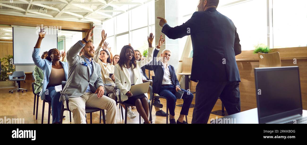 People colleagues raising hands to ask questions during business ...