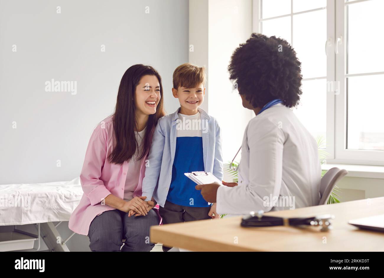 Portrait of a little boy patient with his mother talking with ...