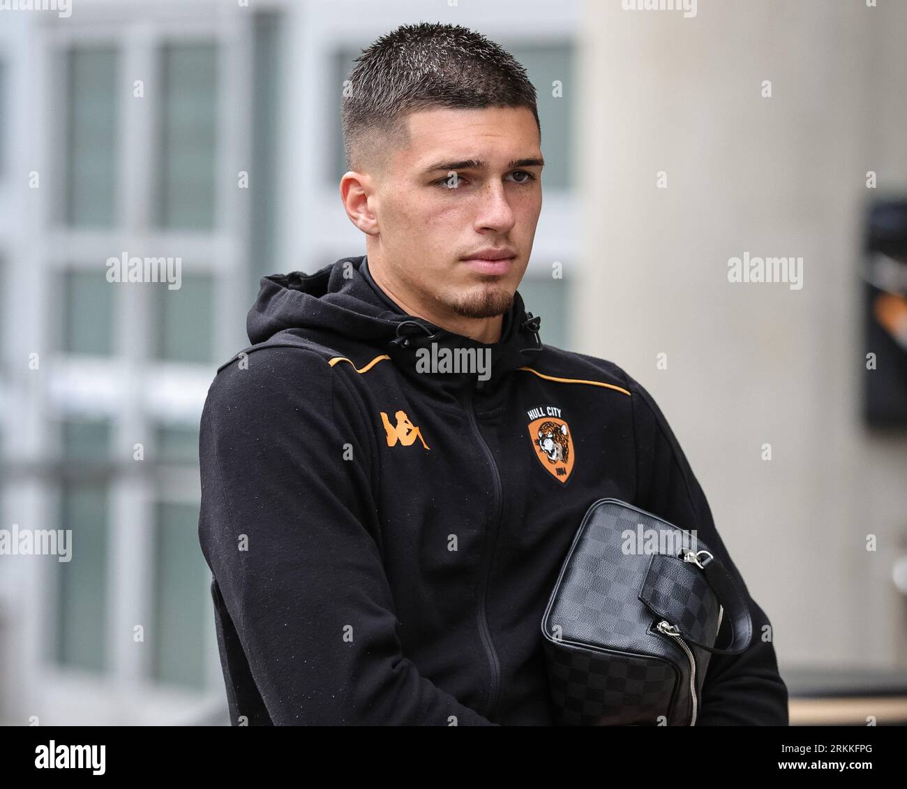 Hull, UK. 25th Aug, 2023. Xavier Simons #18 of Hull City arrives during ...