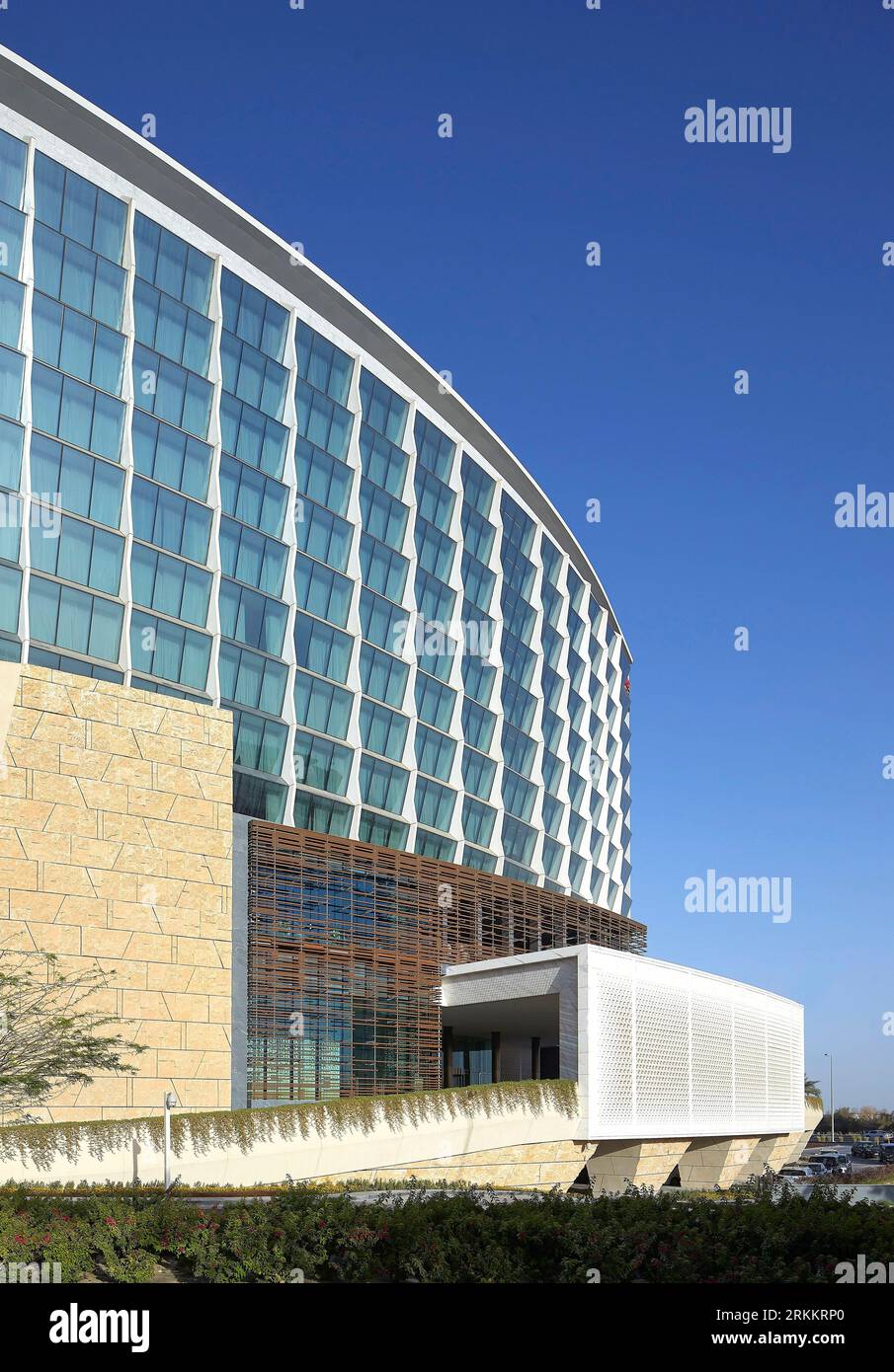 Curved facade with glazing and stone cladding. 360 Mall, Kuweit City ...