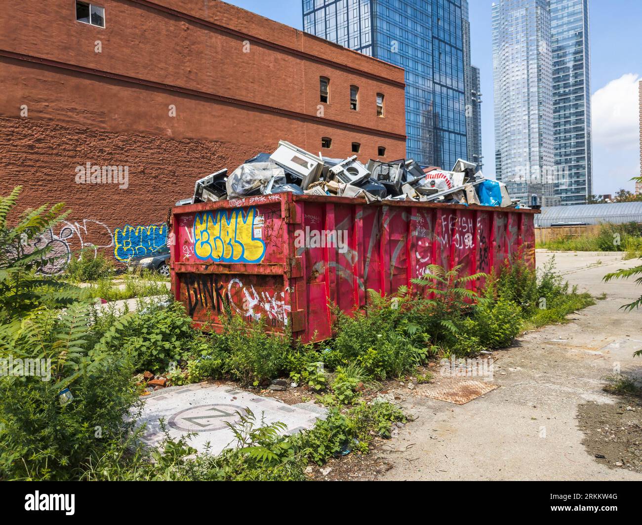 Dumpster filled with discarded air conditioners and other mechanical ...