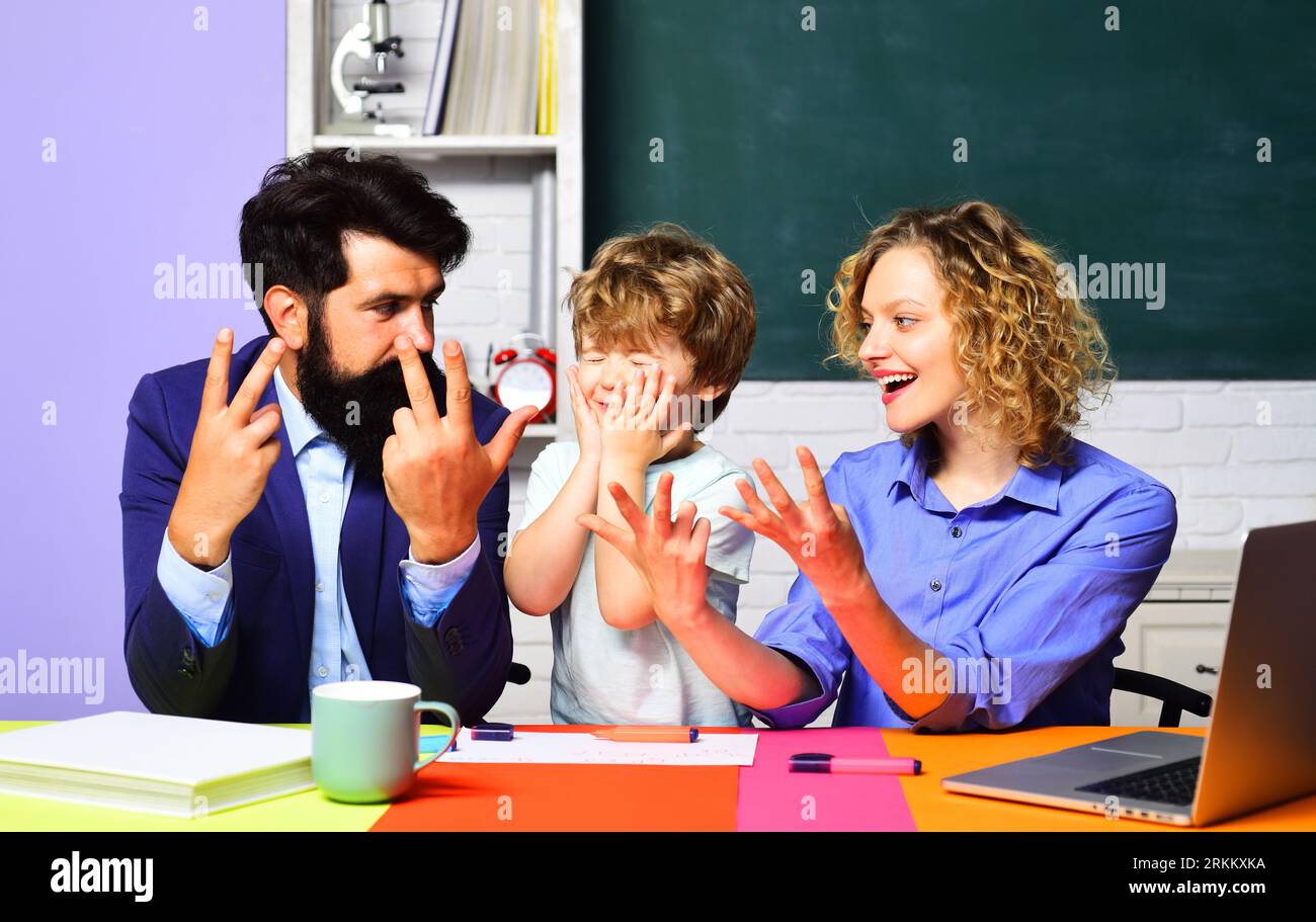 Little child doing math homework with parents. Boy from elementary ...