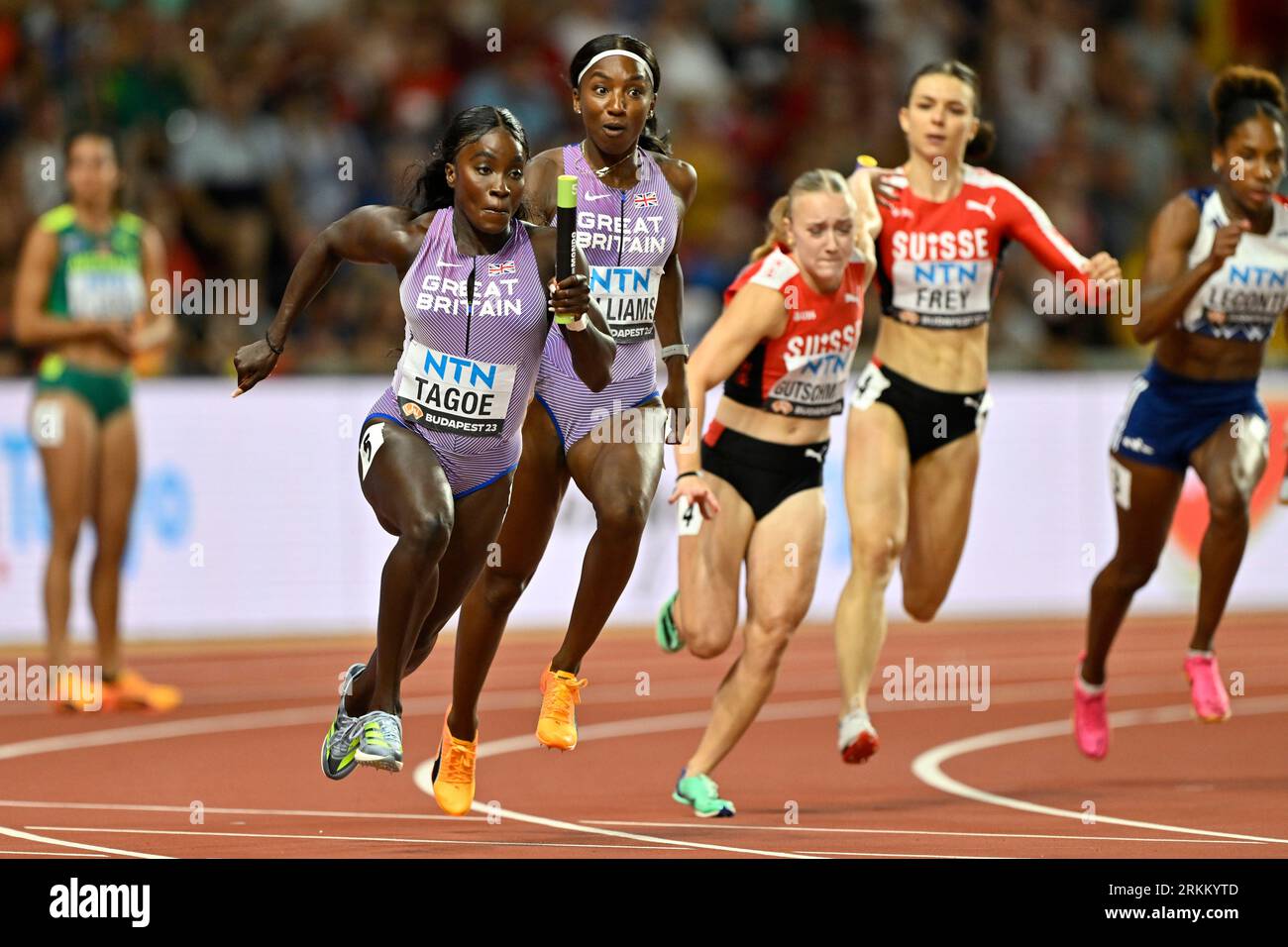 Annie Tagoe, second from left, of Great Britain, runs after taking the ...