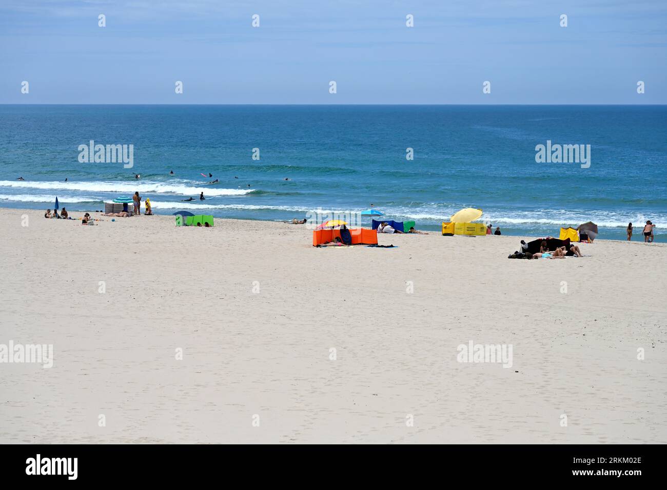 White sandy beach and sea of Praia da Barra just on outskirts of city ...
