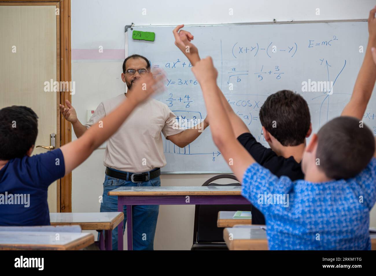 Children's in school so excited with their teacher and raising their ...