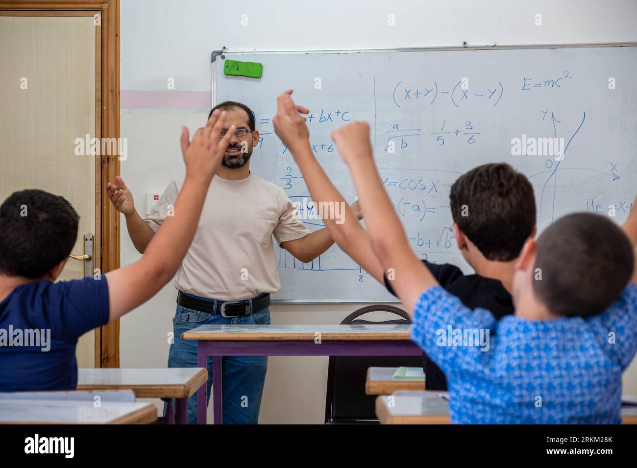 Children's in school so excited with their teacher and raising their ...