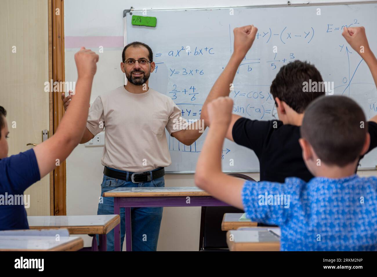 Children's in school so excited with their teacher and raising their ...