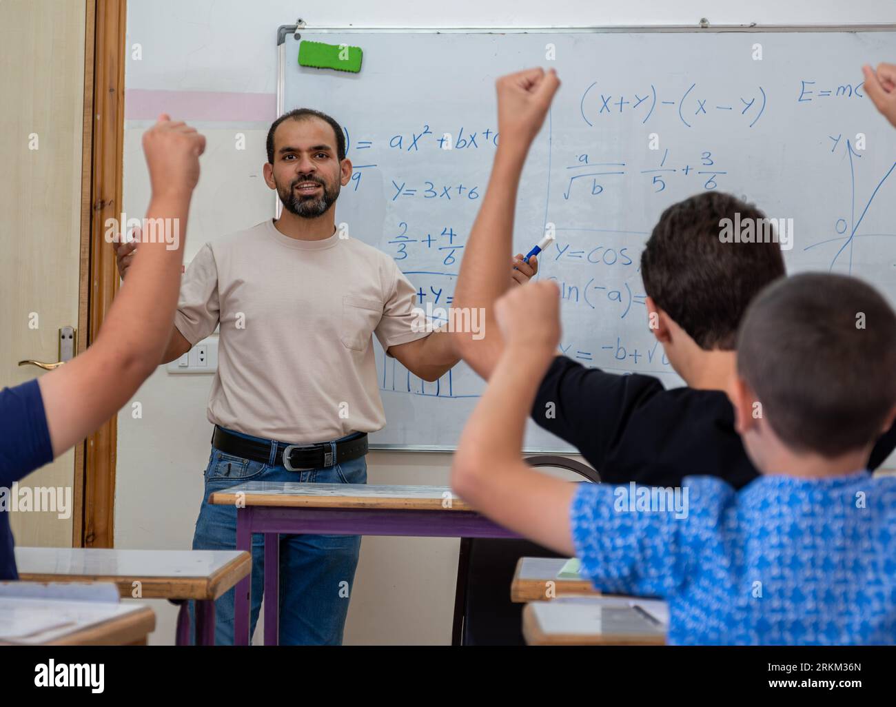 Children's in school so excited with their teacher and raising their ...