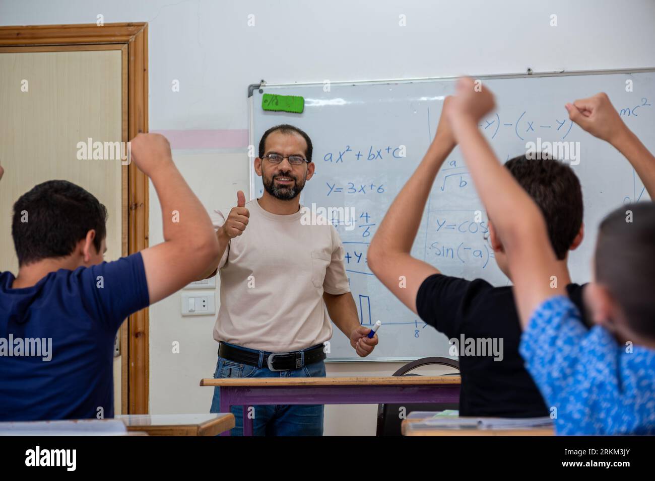 Children's in school so excited with their teacher and raising their ...