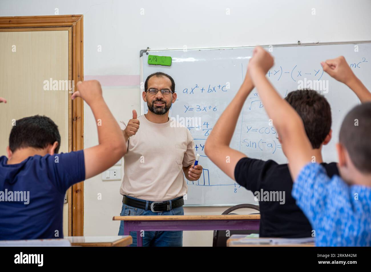 Children's in school so excited with their teacher and raising their ...