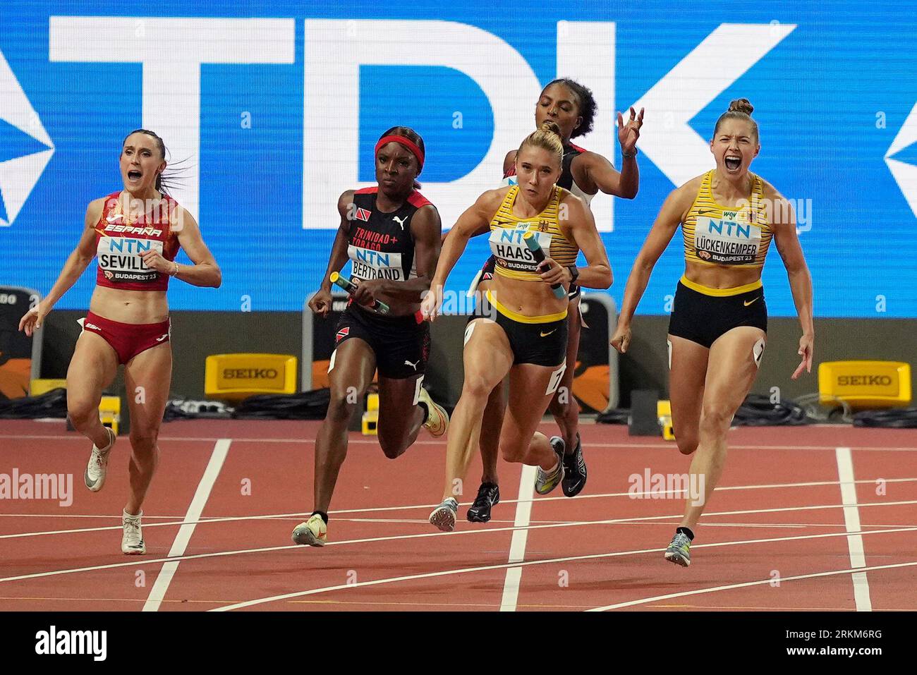 Gina Lückenkemper, right, of Germany, reacts after handing the baton off to Rebekka Haase in a ...