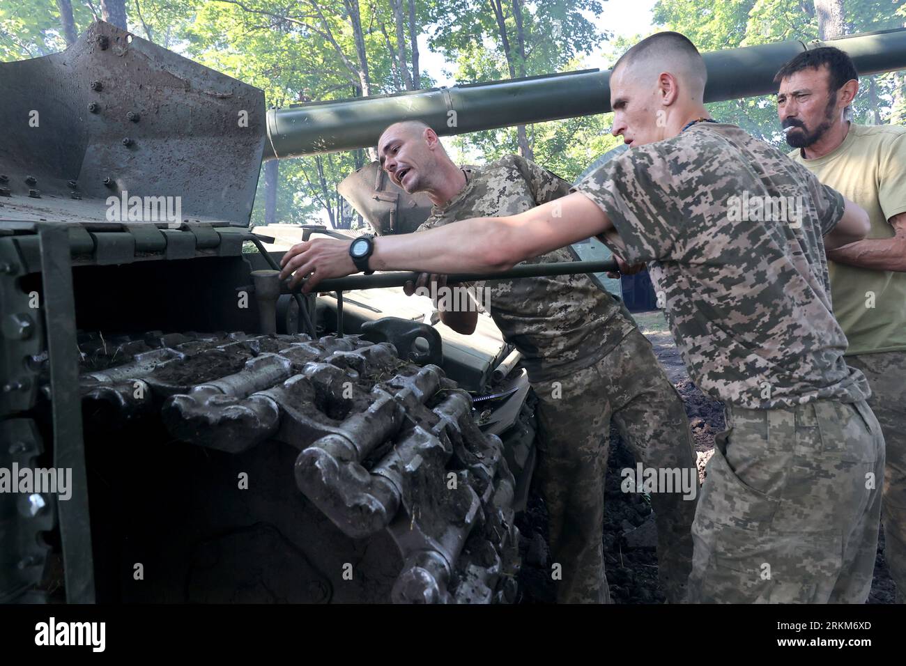 KHARKIV REGION, UKRAINE - AUGUST 16, 2023 - Servicemen repair a tank as ...