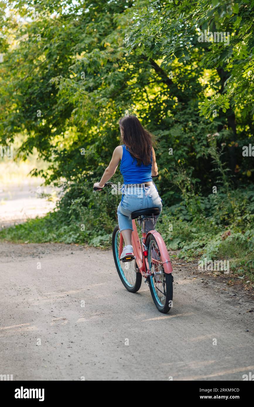 Woman bicycle rear view hi-res stock photography and images - Alamy