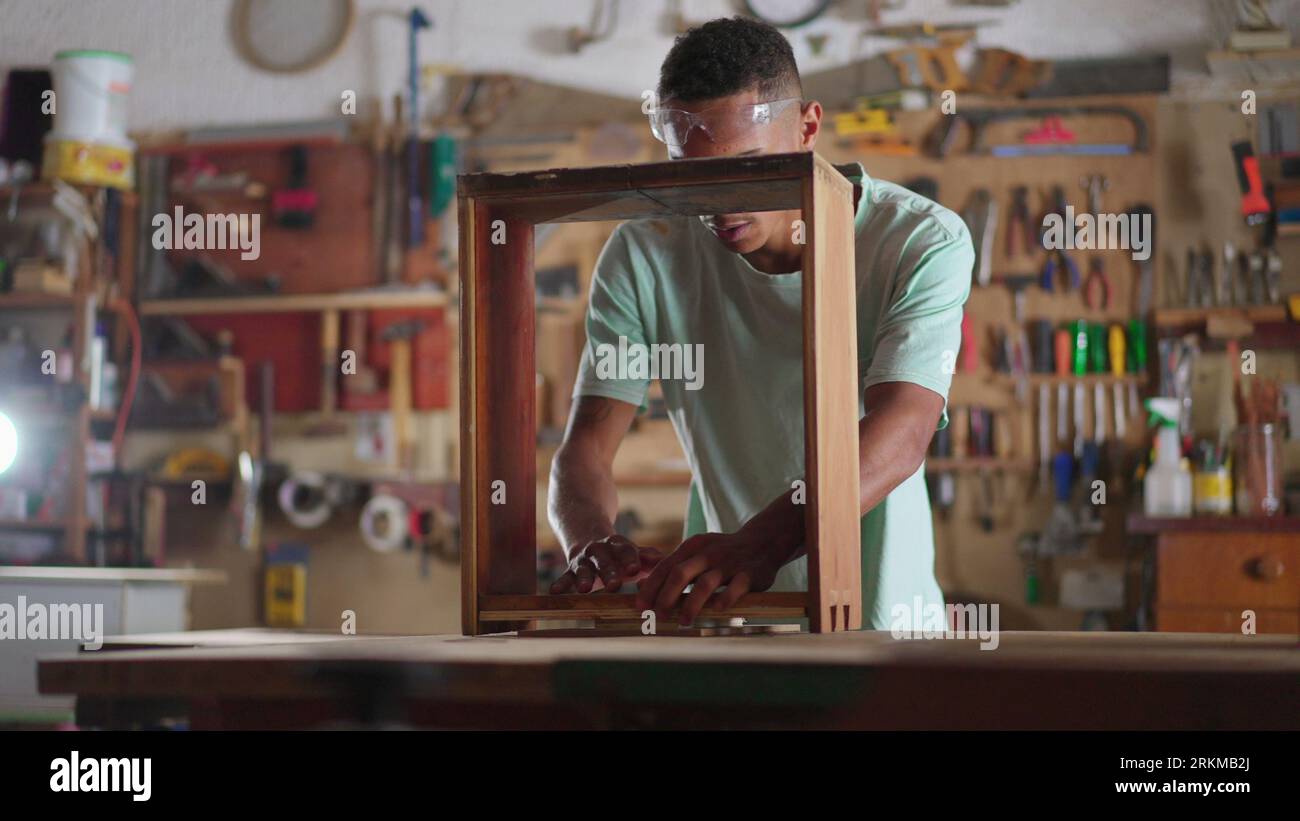 Carpentry workshop scene young black hi-res stock photography and ...