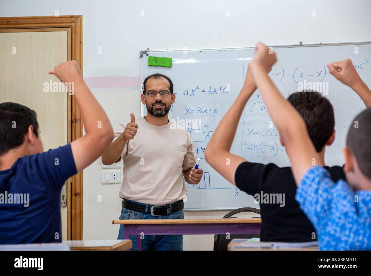 Children's in school so excited with their teacher and raising their ...