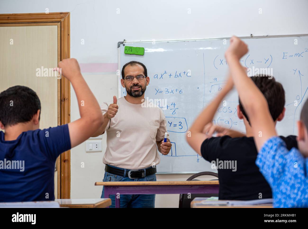 Children's in school so excited with their teacher and raising their ...