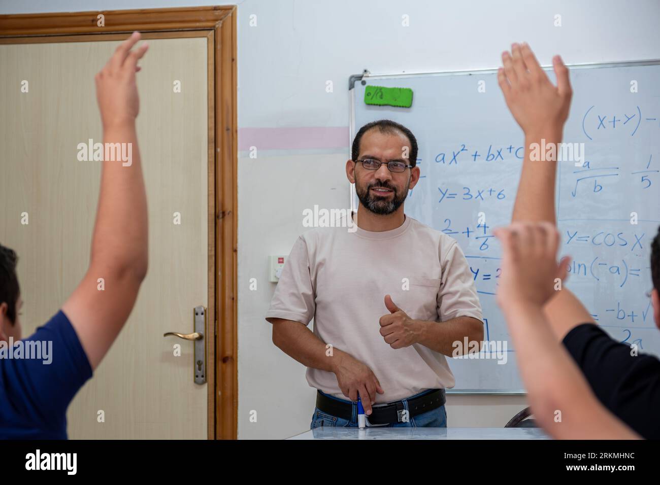Children's in school so excited with their teacher and raising their ...