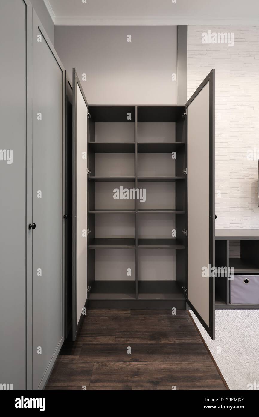 Open wardrobe with shelves in the room interior Stock Photo - Alamy