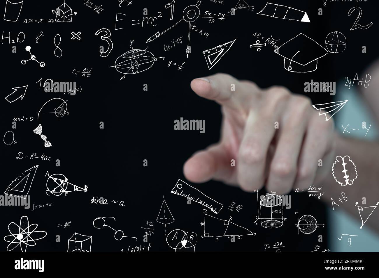 Male hand writing mathematical formulas on blurry background. Science ...