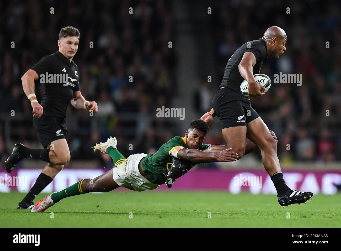 Mark Telea of New Zealand breaks the tackle of Canan Moodie of South ...