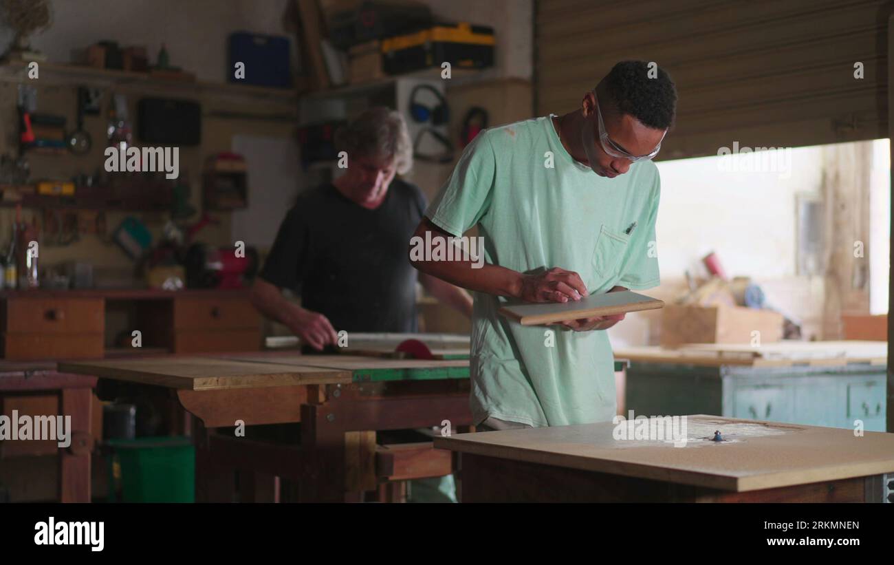 Candid Carpentry Workshop Scene of Master Carpenter and Apprentice at ...