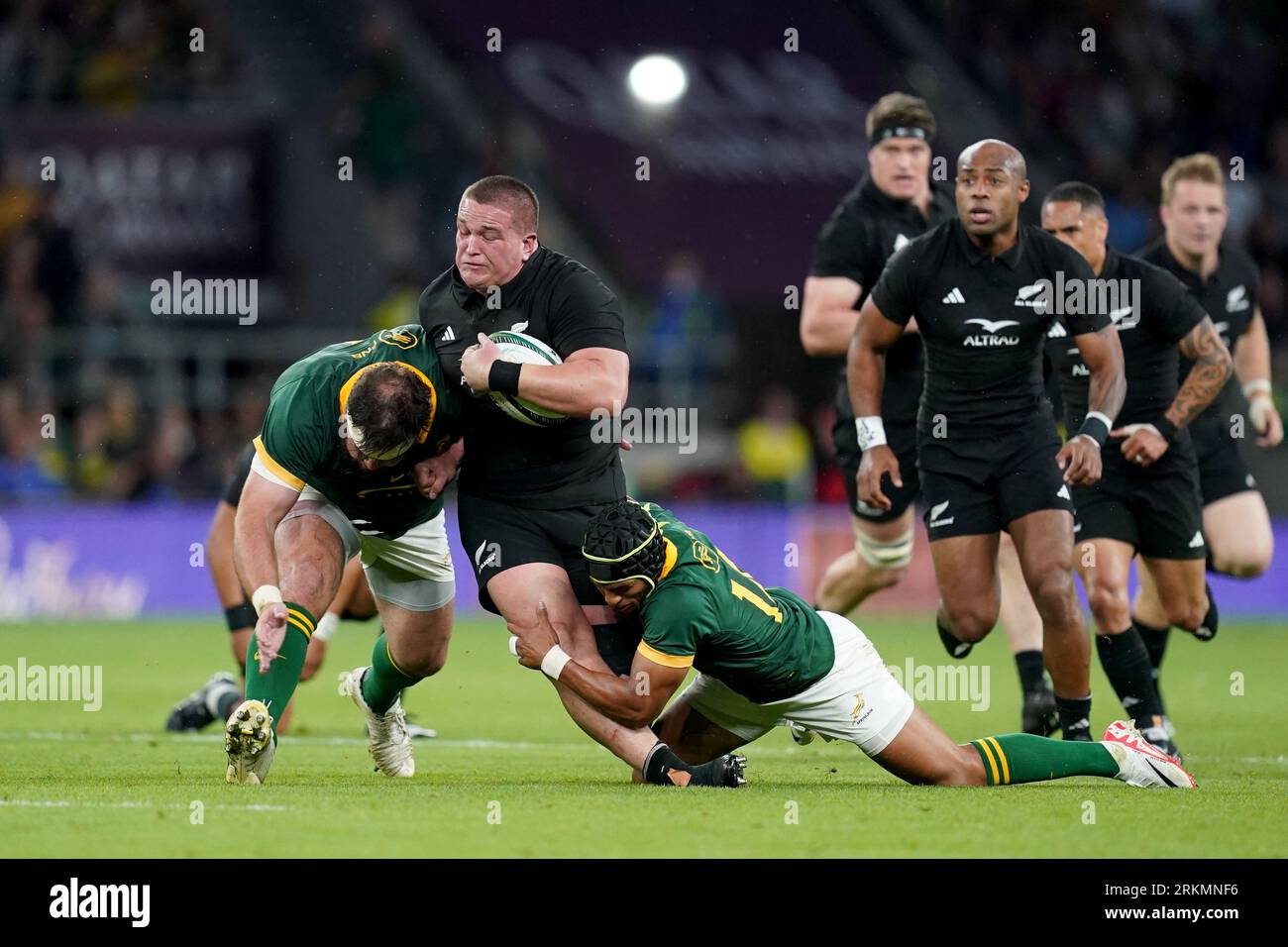 New Zealand's Ethan de Groot (centre) is tackled by South Africa's Kurt ...