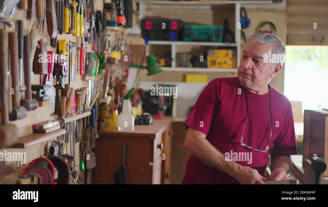 Senior man organizing tools hanging hi-res stock photography and images ...