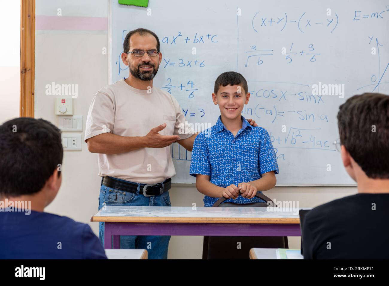 Teacher with his best student in class room Stock Photo - Alamy