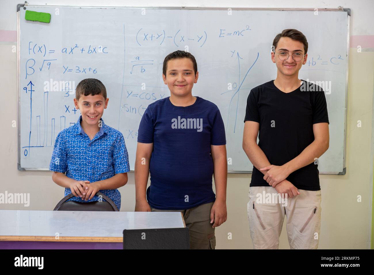 school kids standing beside each other while smiling Stock Photo - Alamy