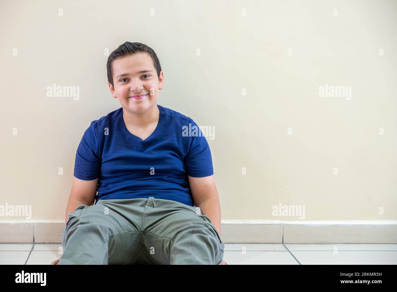 Portrait for a child sitting in the school corridor Stock Photo - Alamy