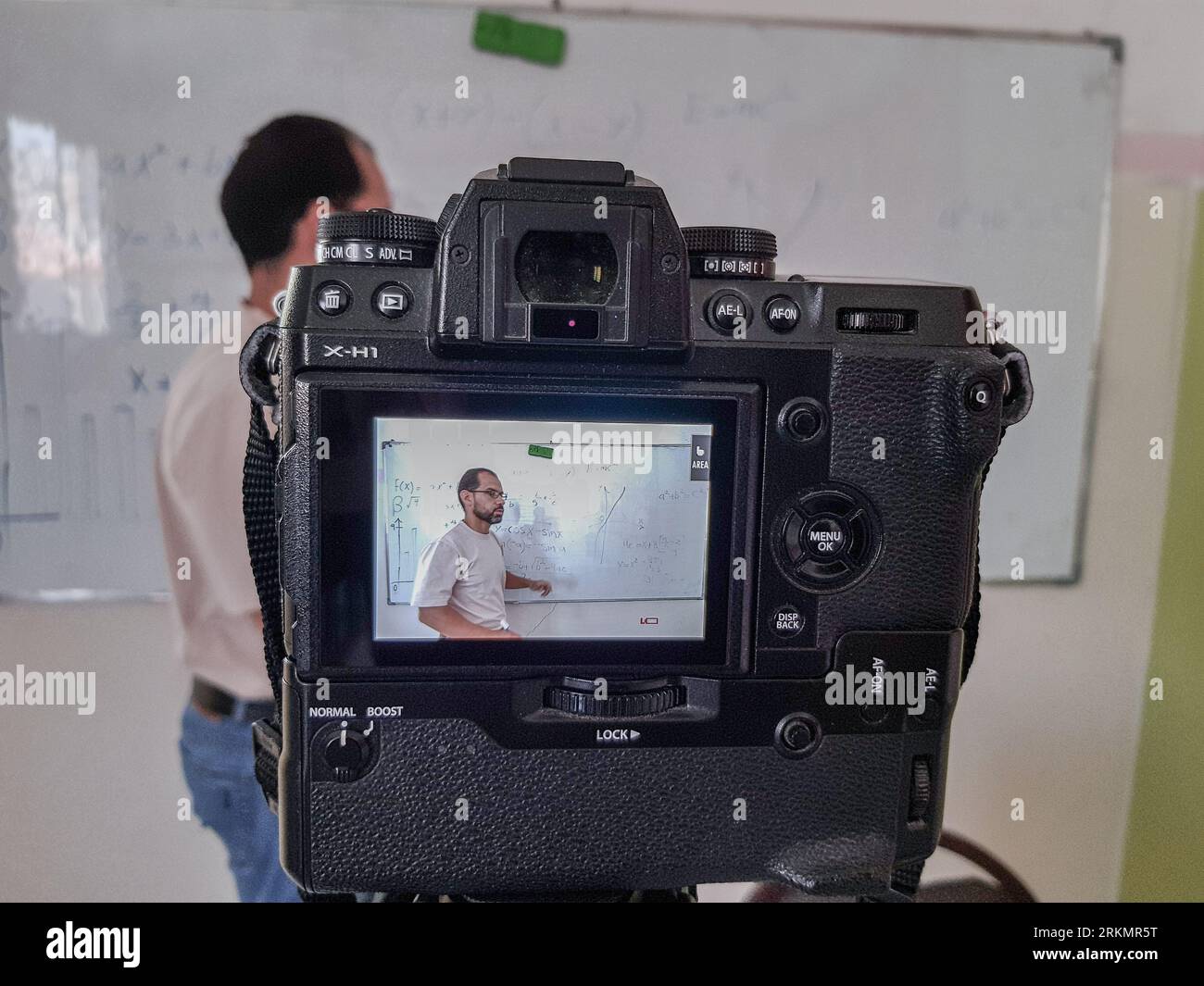 Teacher filming and streaming his lessons for the students through ...